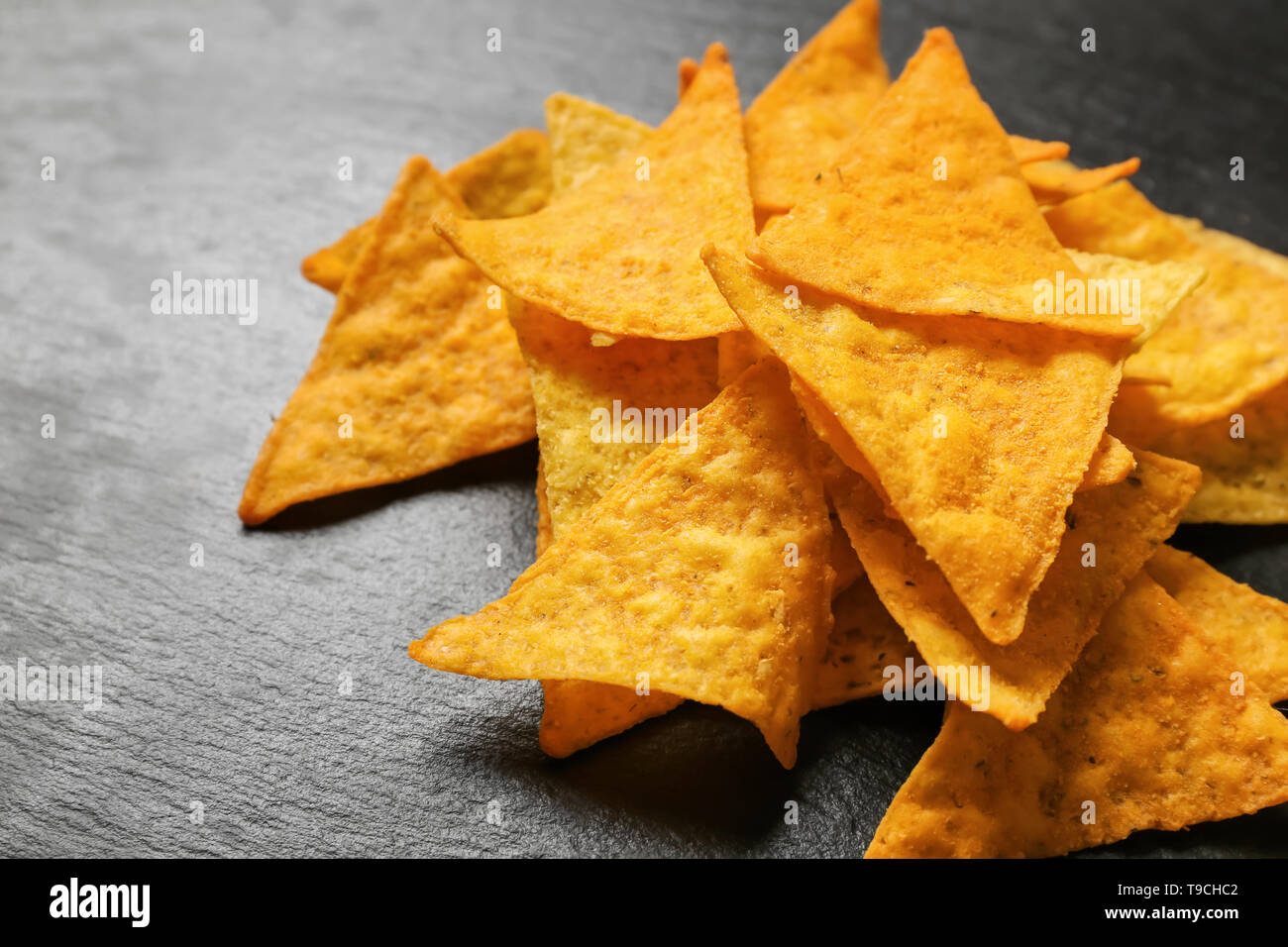 Corn chips on dark background Stock Photo - Alamy