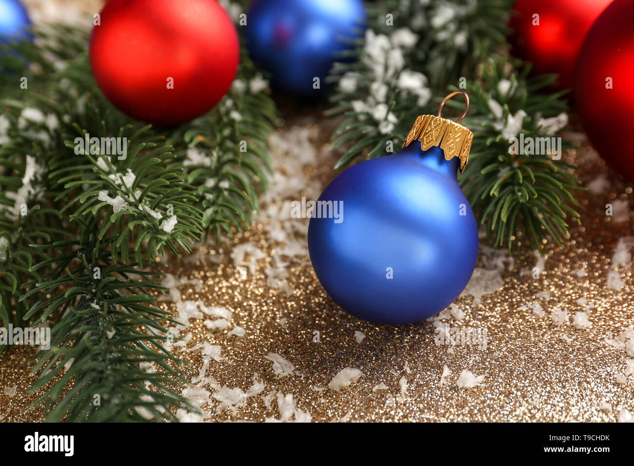 Christmas ball with fir tree branches on color background Stock Photo ...