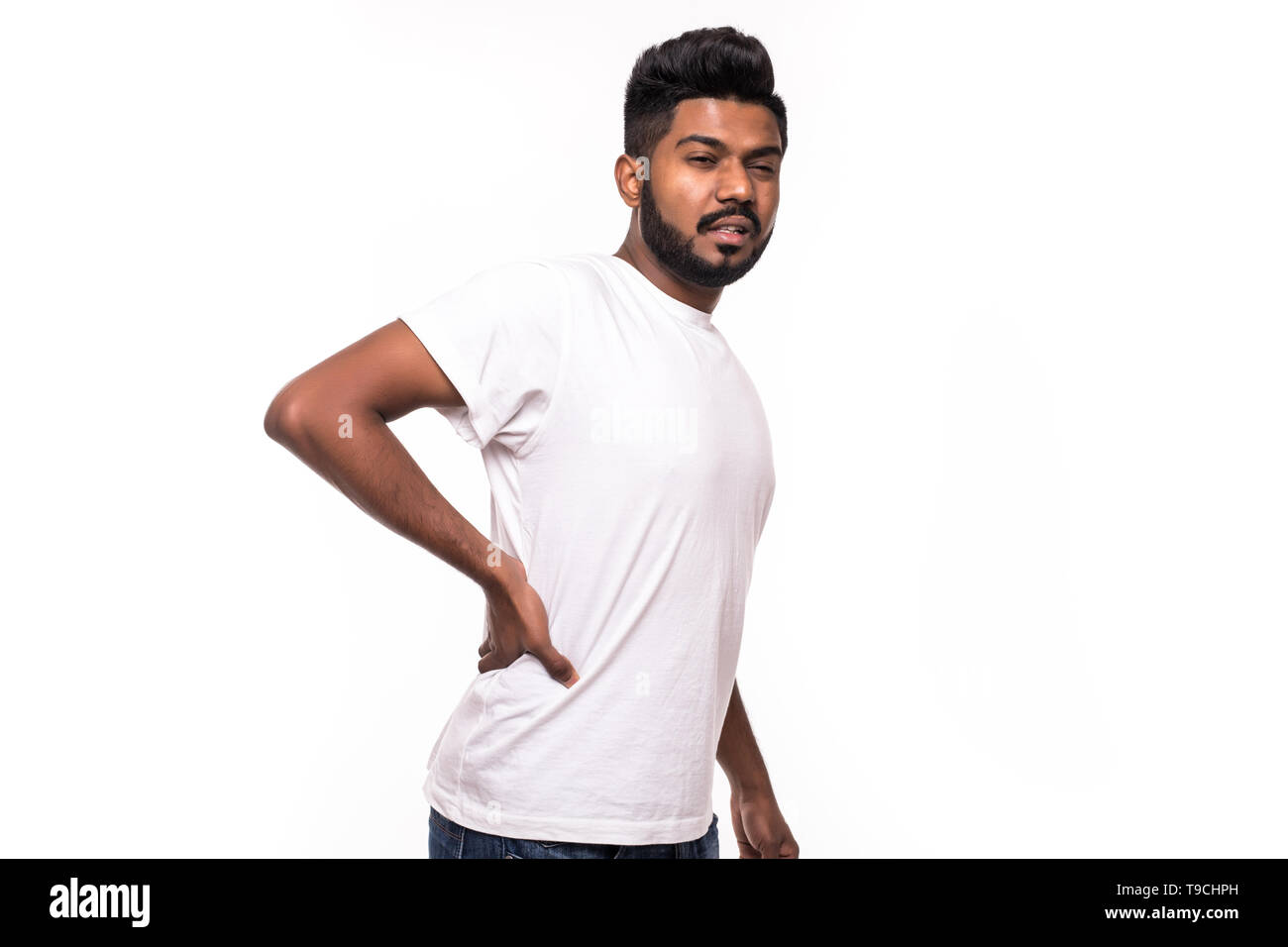 Indian man suffering from Back Pain or injury isolated over white ...