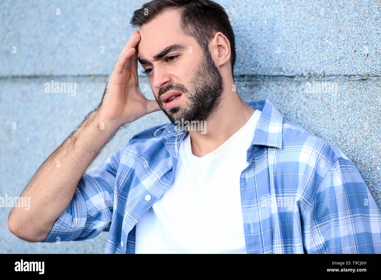 Portrait of stressed young man outdoors Stock Photo - Alamy