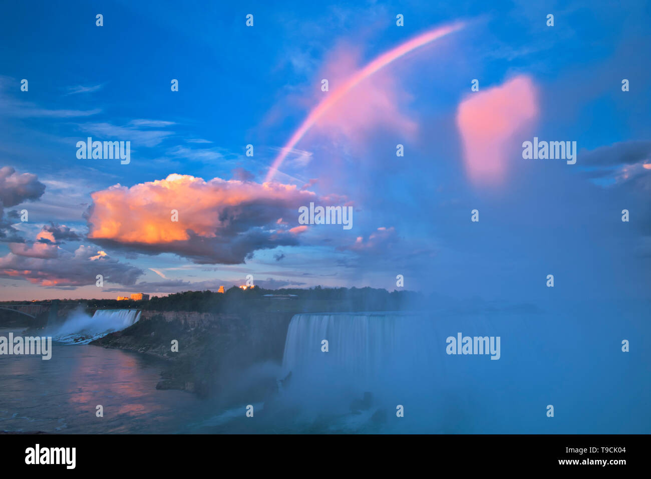Storm clouds at sunrise with fog and rainbow as The Niagara River ...
