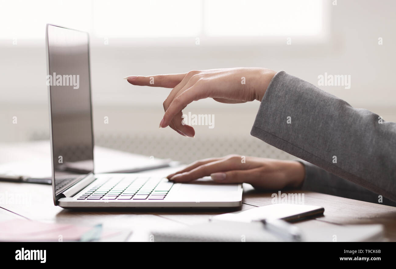 Female Manager Pointing Finger On Laptop Screen Stock Photo - Alamy