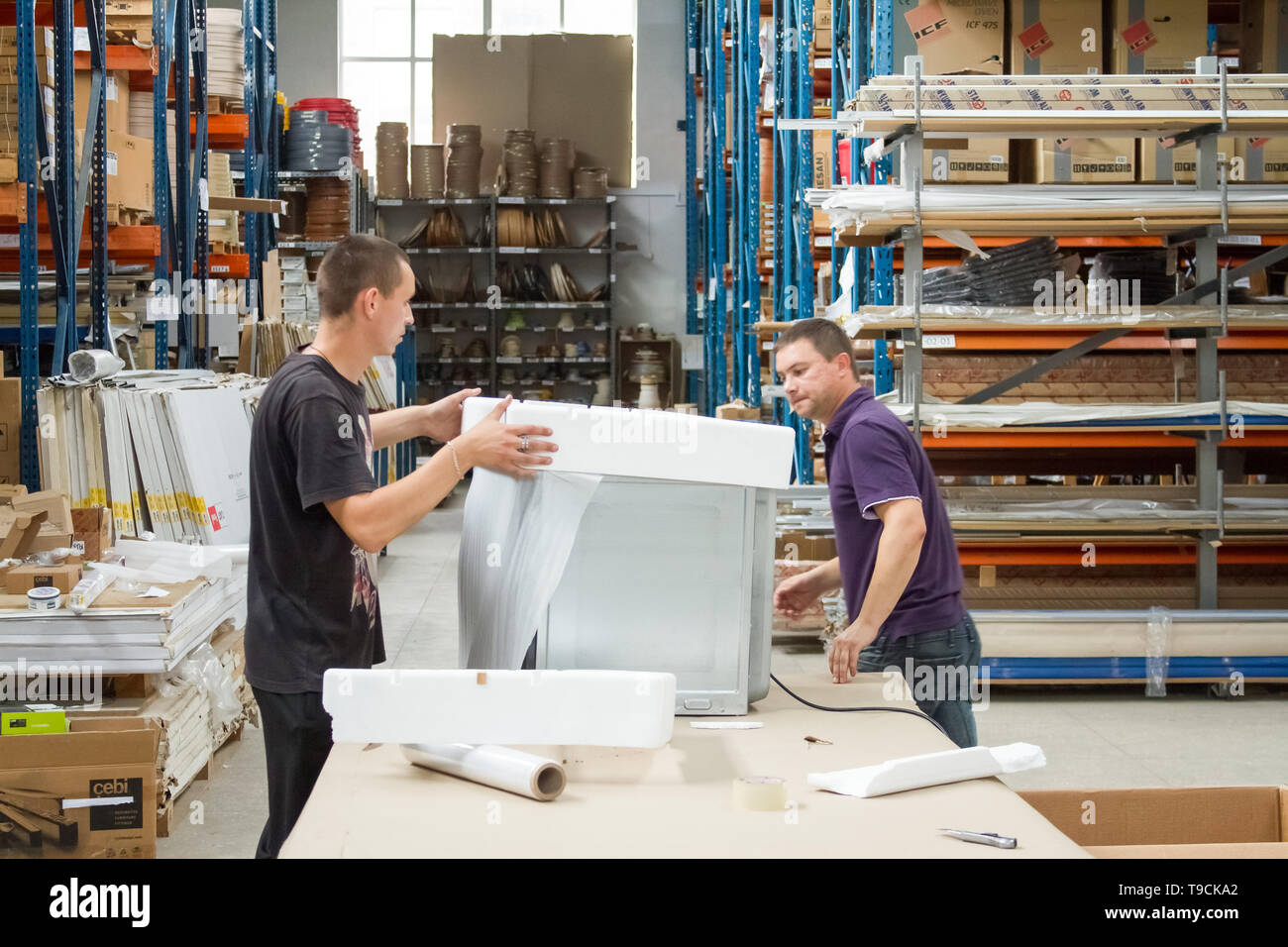 Warehouse workers pack equipment before shipment to customer Stock ...