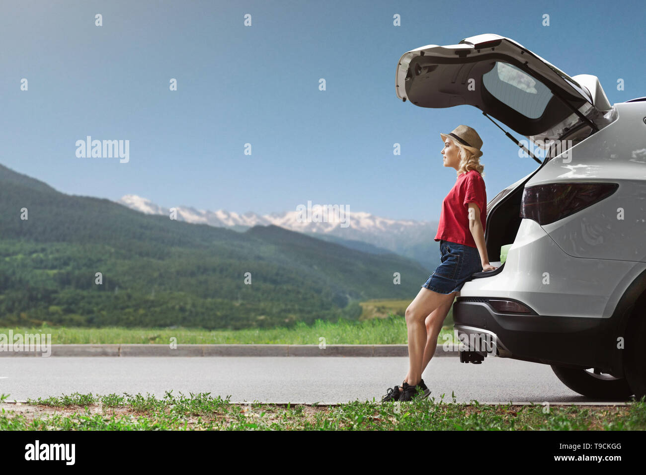 Girl standing near car on road Stock Photo - Alamy