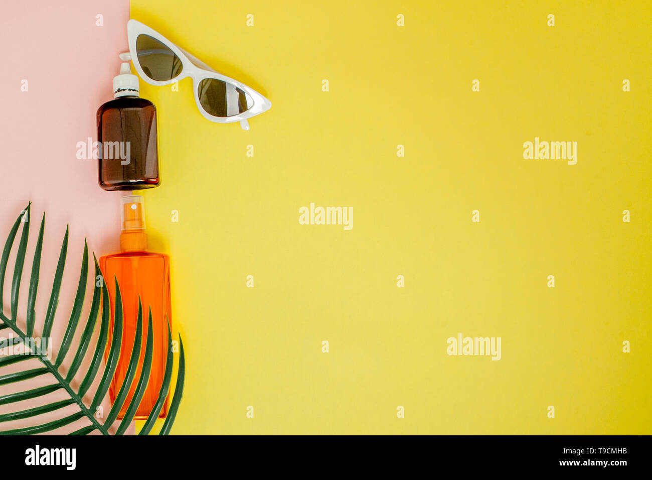 Bottle sunblock on bright square yellow and pink background. The ...