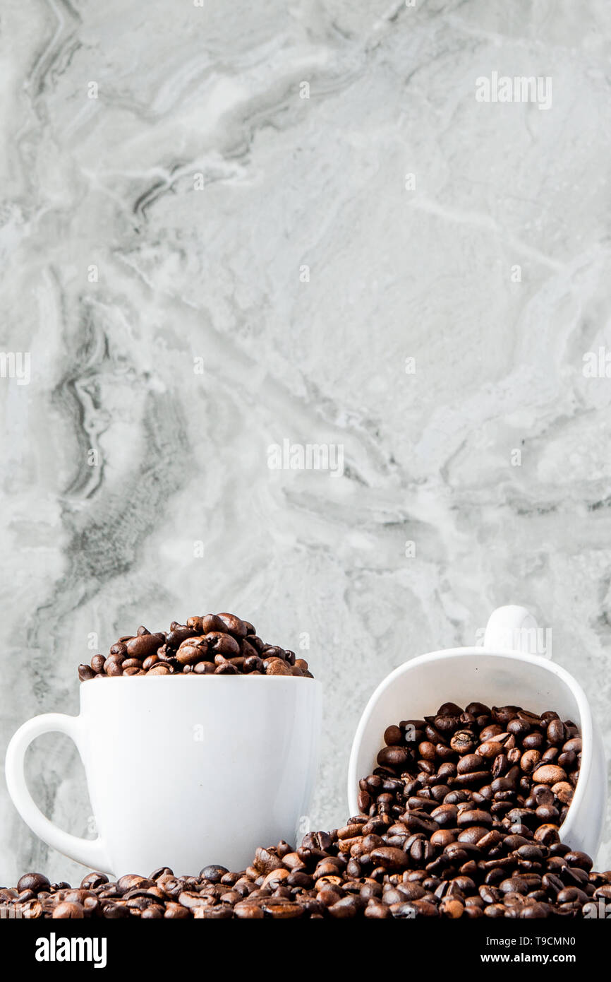 Black coffee in cup and coffee beans on marble background. Top view ...