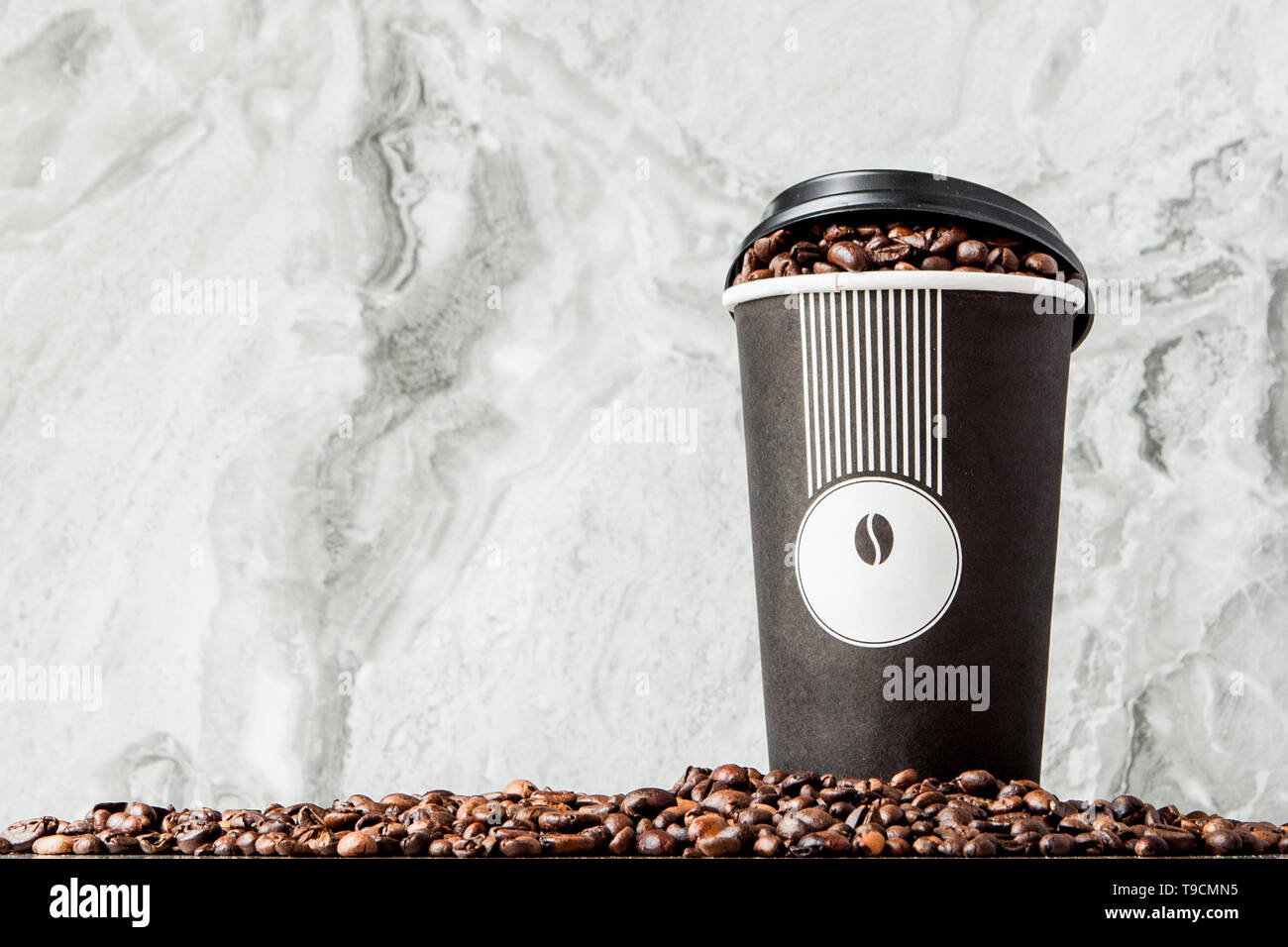 Black coffee in cup and coffee beans on marble background. Top view ...