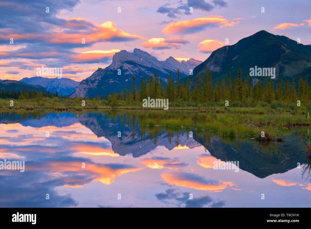 Clouds and Mt. Rundle and Sulphur Mountain reflected in Vermillion ...