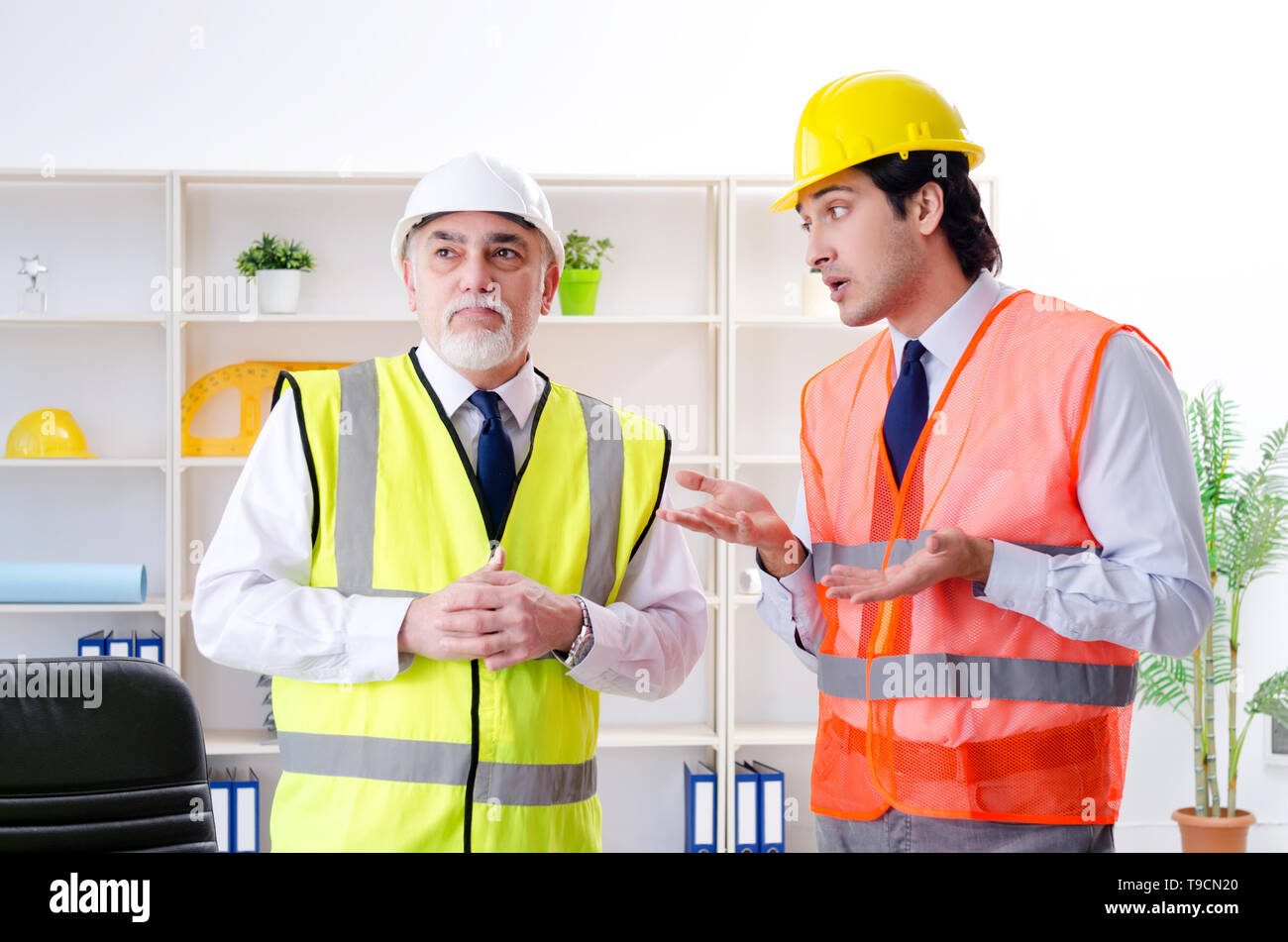 Two engineers colleagues working under project Stock Photo - Alamy