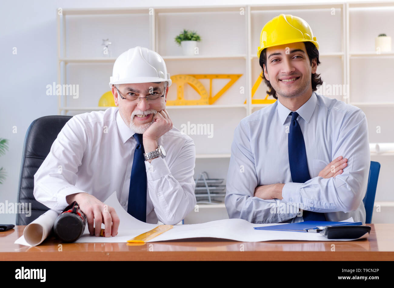 Two engineers colleagues working under project Stock Photo - Alamy