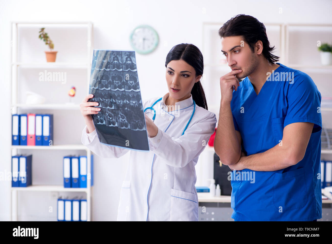 Two young doctors working in the clinic Stock Photo - Alamy