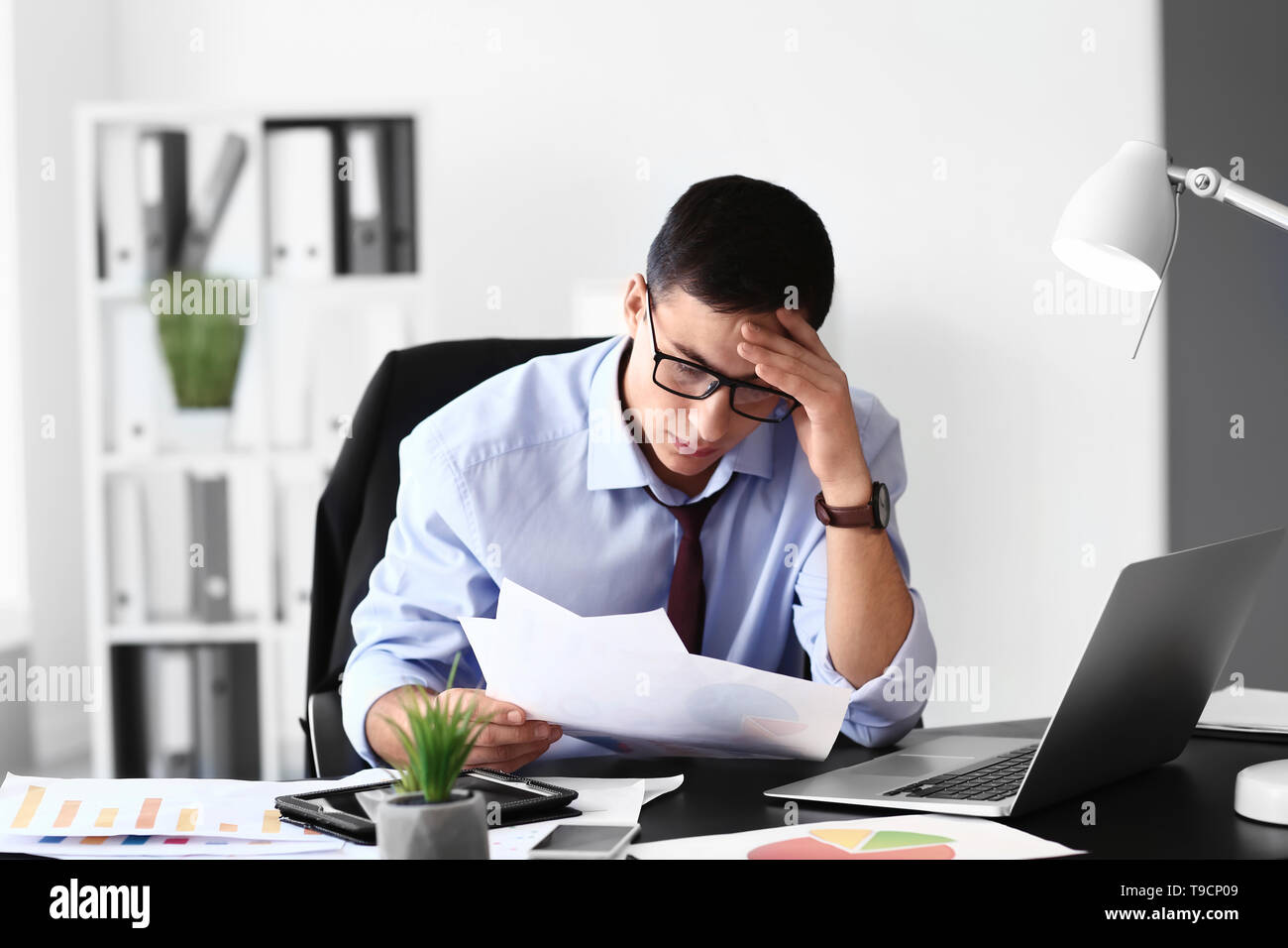 Stressed young businessman in office Stock Photo - Alamy
