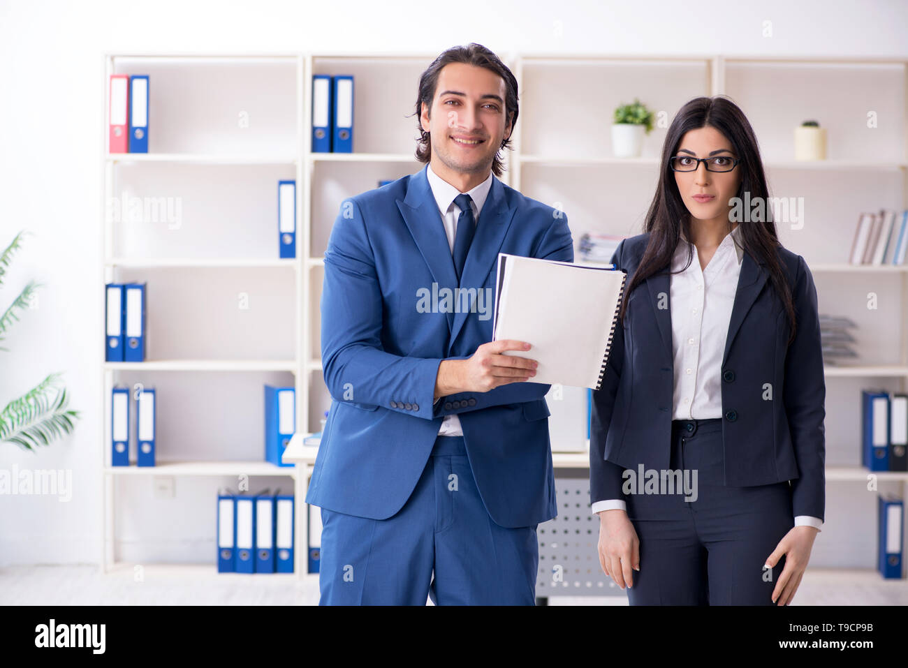 Two employees working in the office Stock Photo - Alamy