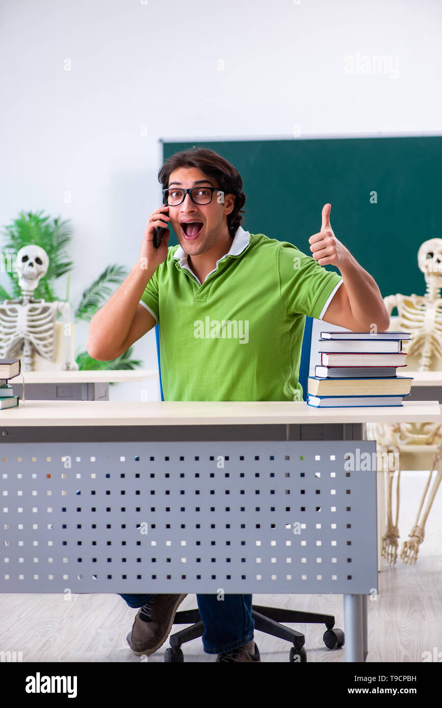 Funny male student in the classroom with skeleton Stock Photo - Alamy