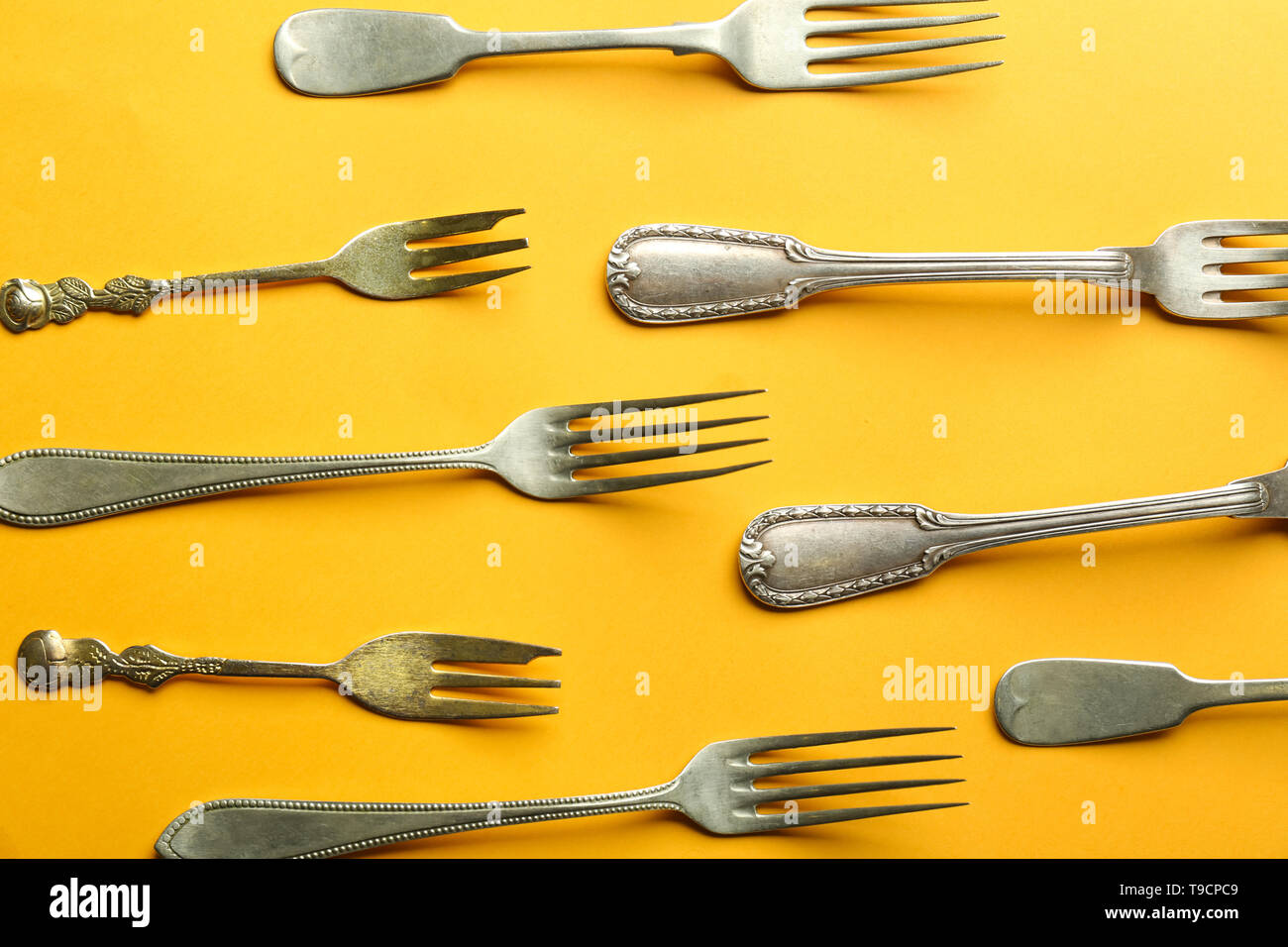 Set of forks on colour background Stock Photo - Alamy