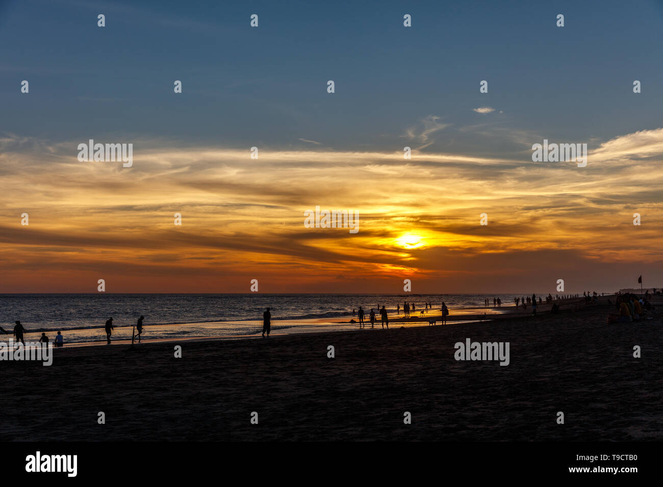 Berawa beach (Pantai Berawa) at sunset. Silhouettes of people walking ...