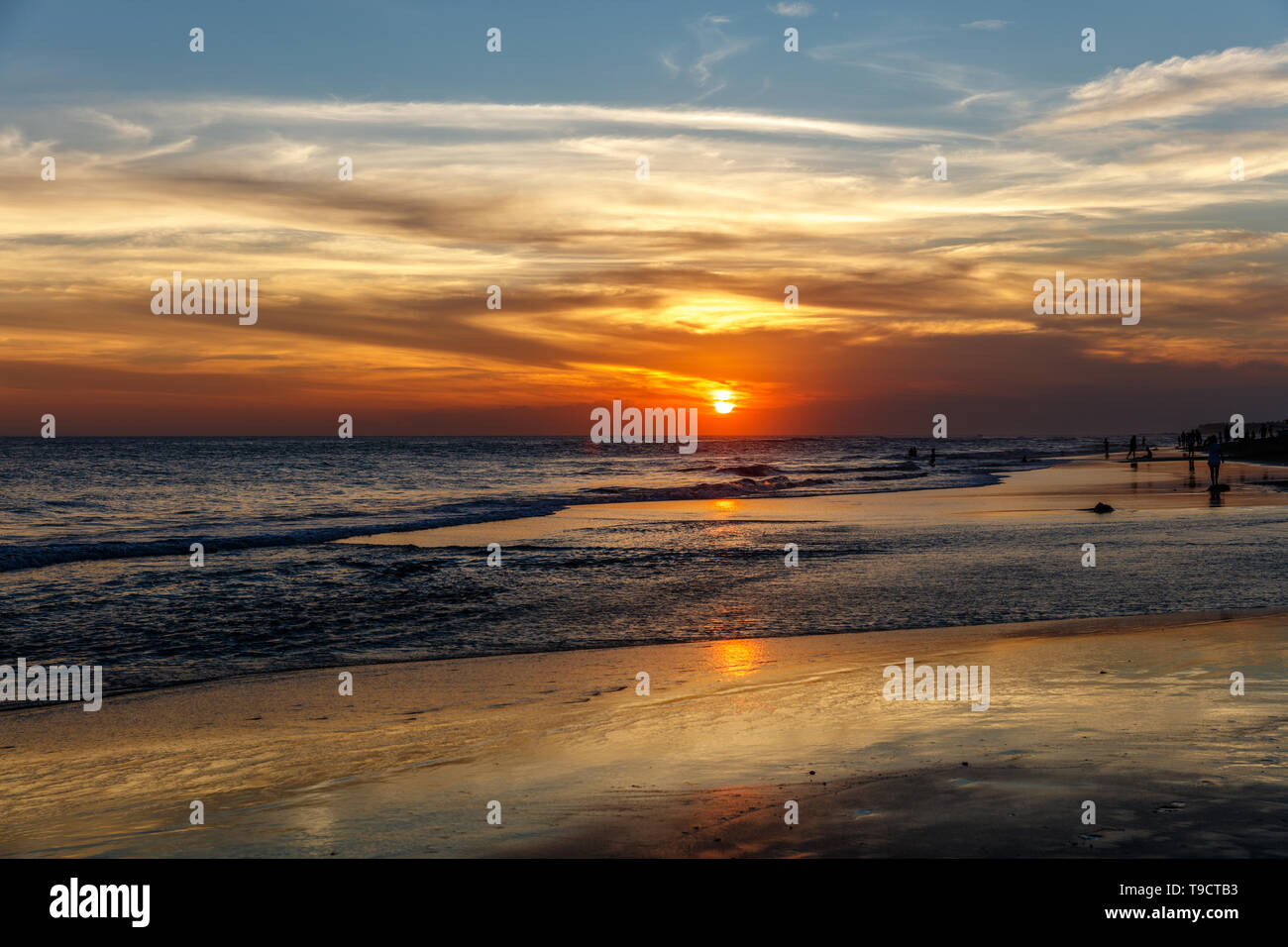 Berawa beach (Pantai Berawa) at sunset. Silhouettes of people walking ...