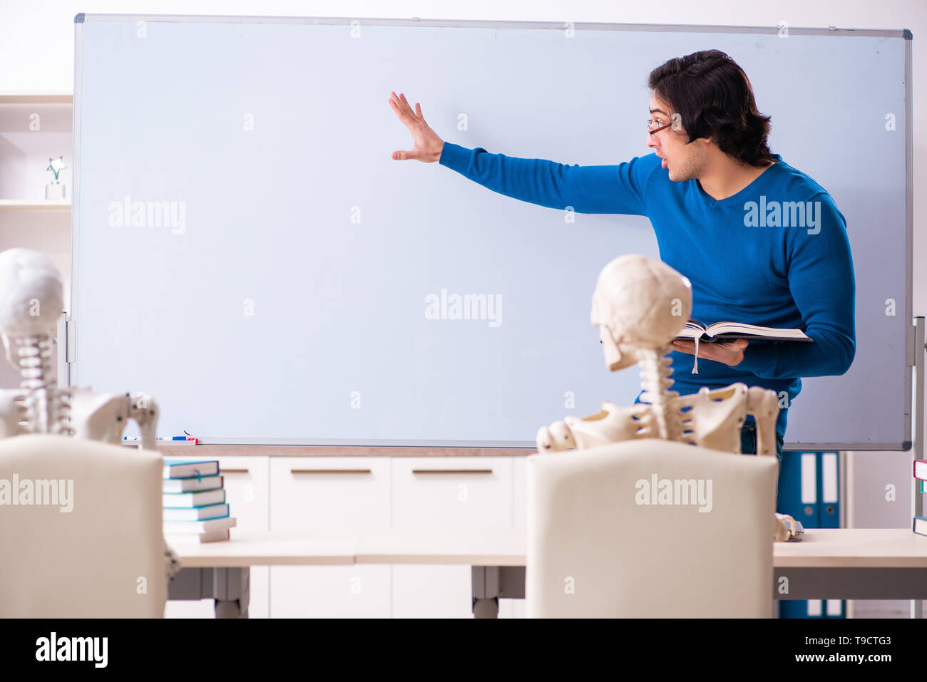 Male teacher and skeleton student in the classroom Stock Photo - Alamy