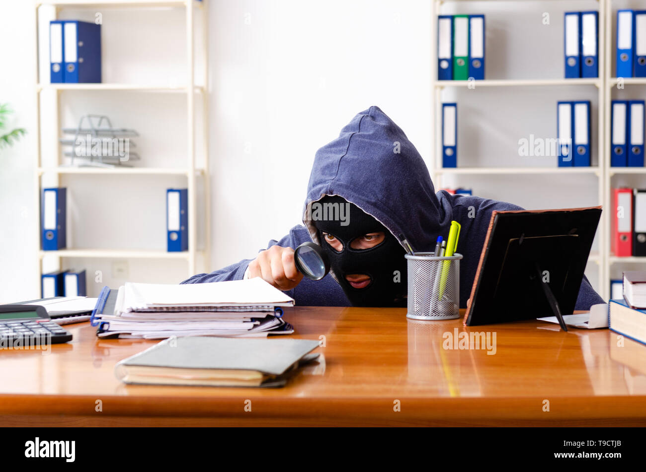 Male thief in balaclava in the office Stock Photo - Alamy