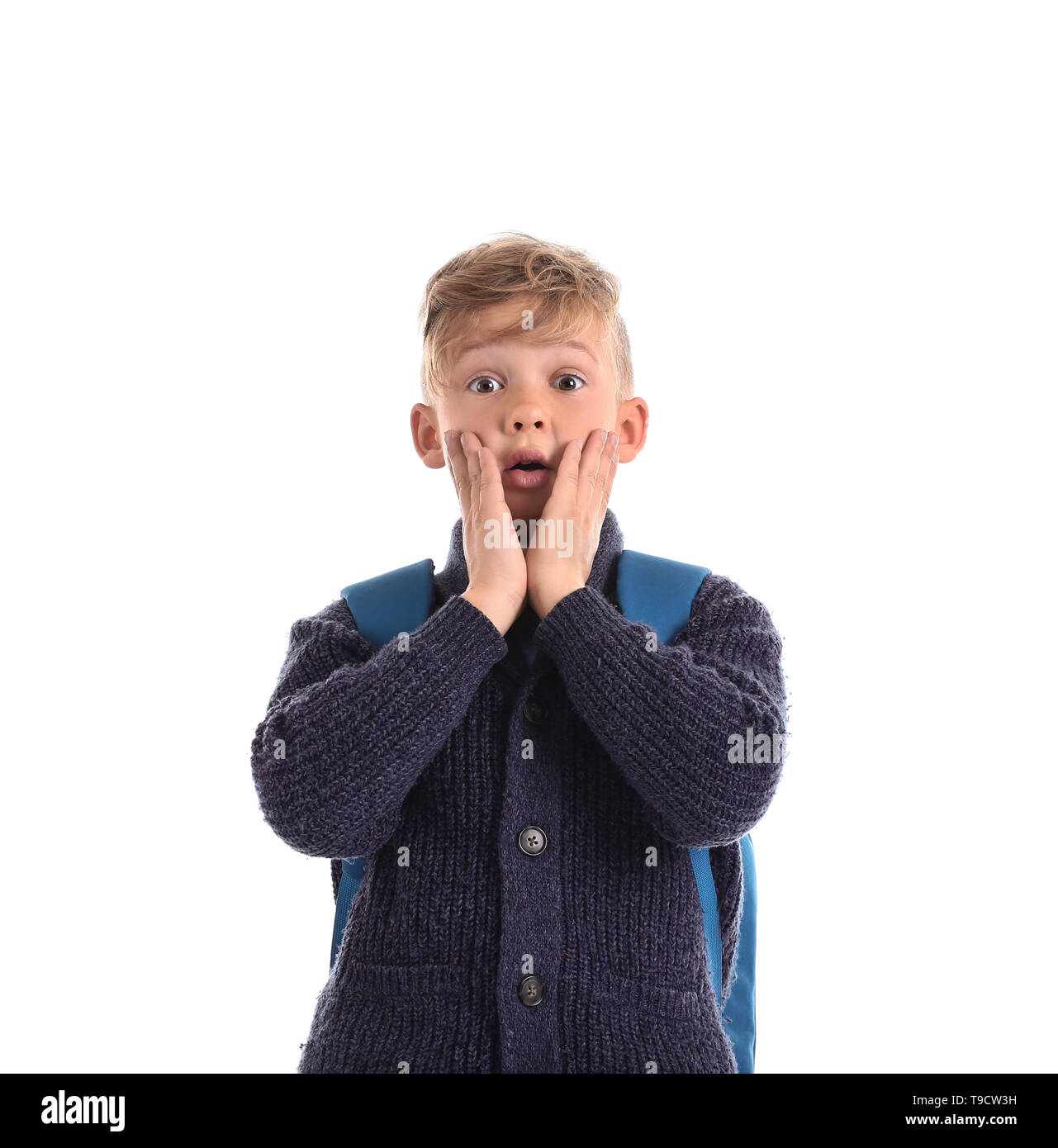 Shocked little schoolboy with backpack on white background Stock Photo ...