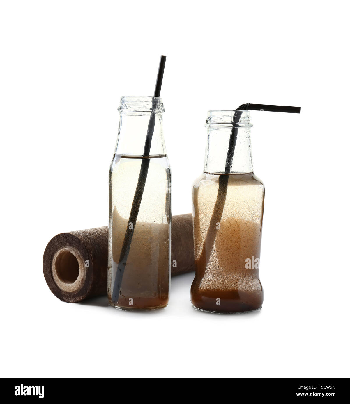 Bottles with dirty liquid and used water filter on white background ...