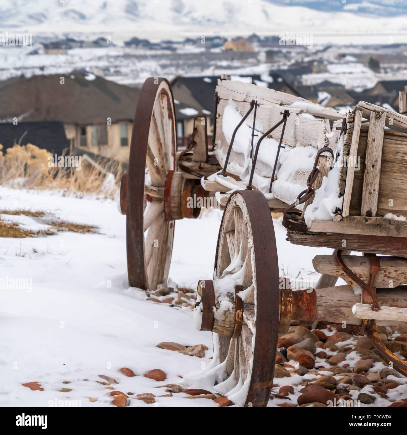 Clear Square Weathered wooden wagon with chains and rusty wheel viewed ...