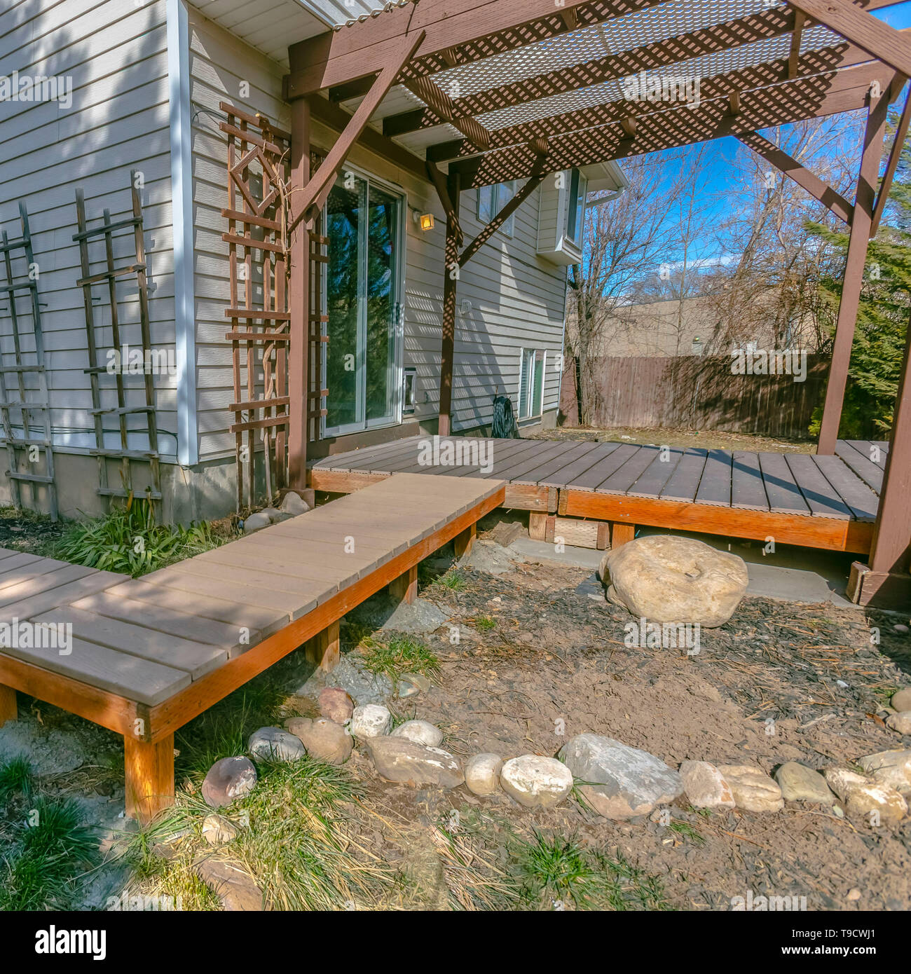 Clear Square Exterior of a home with a wooden walkway and deck on the ...