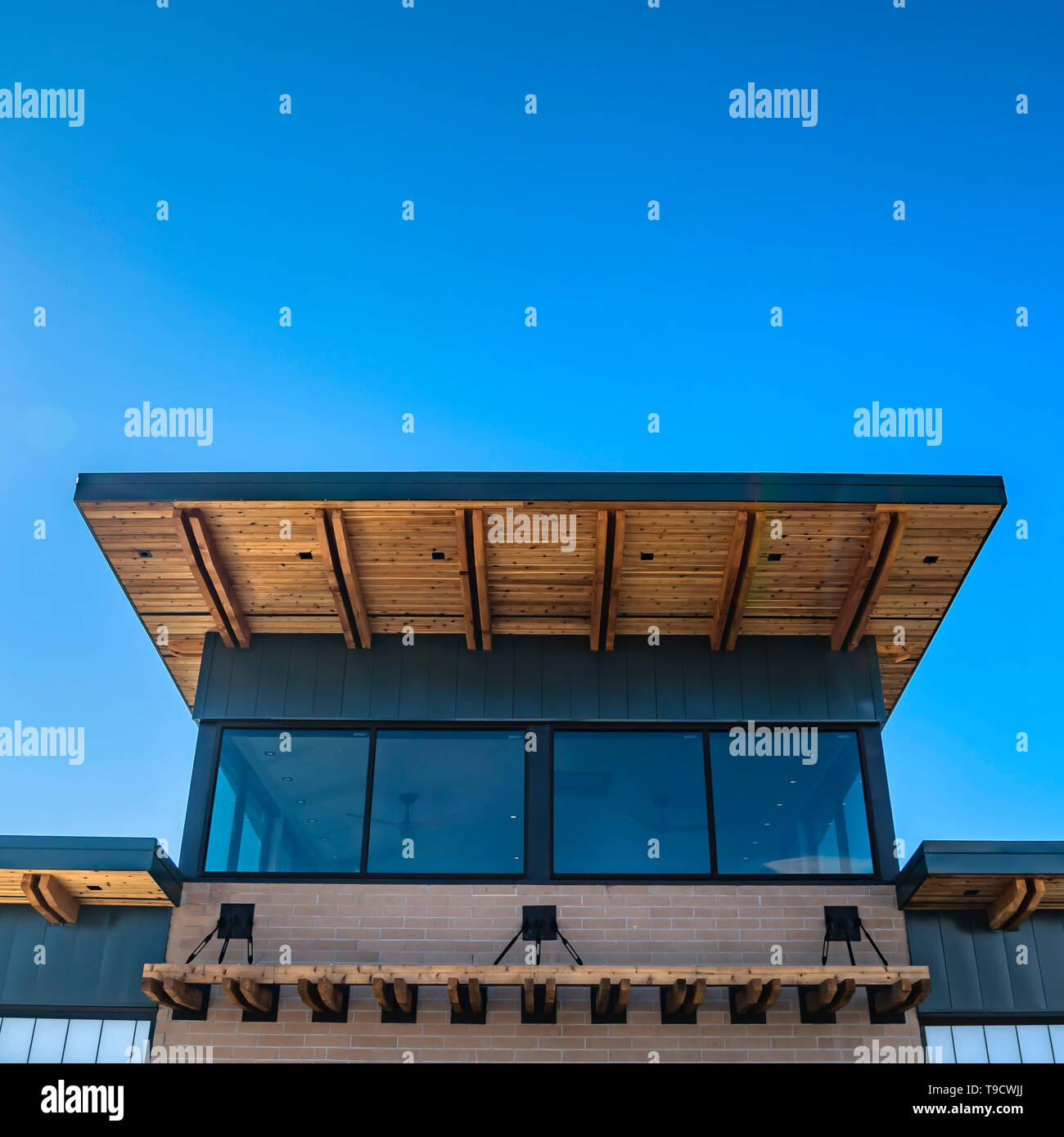 Square Exterior of a red brick building with flat roof and huge glass ...