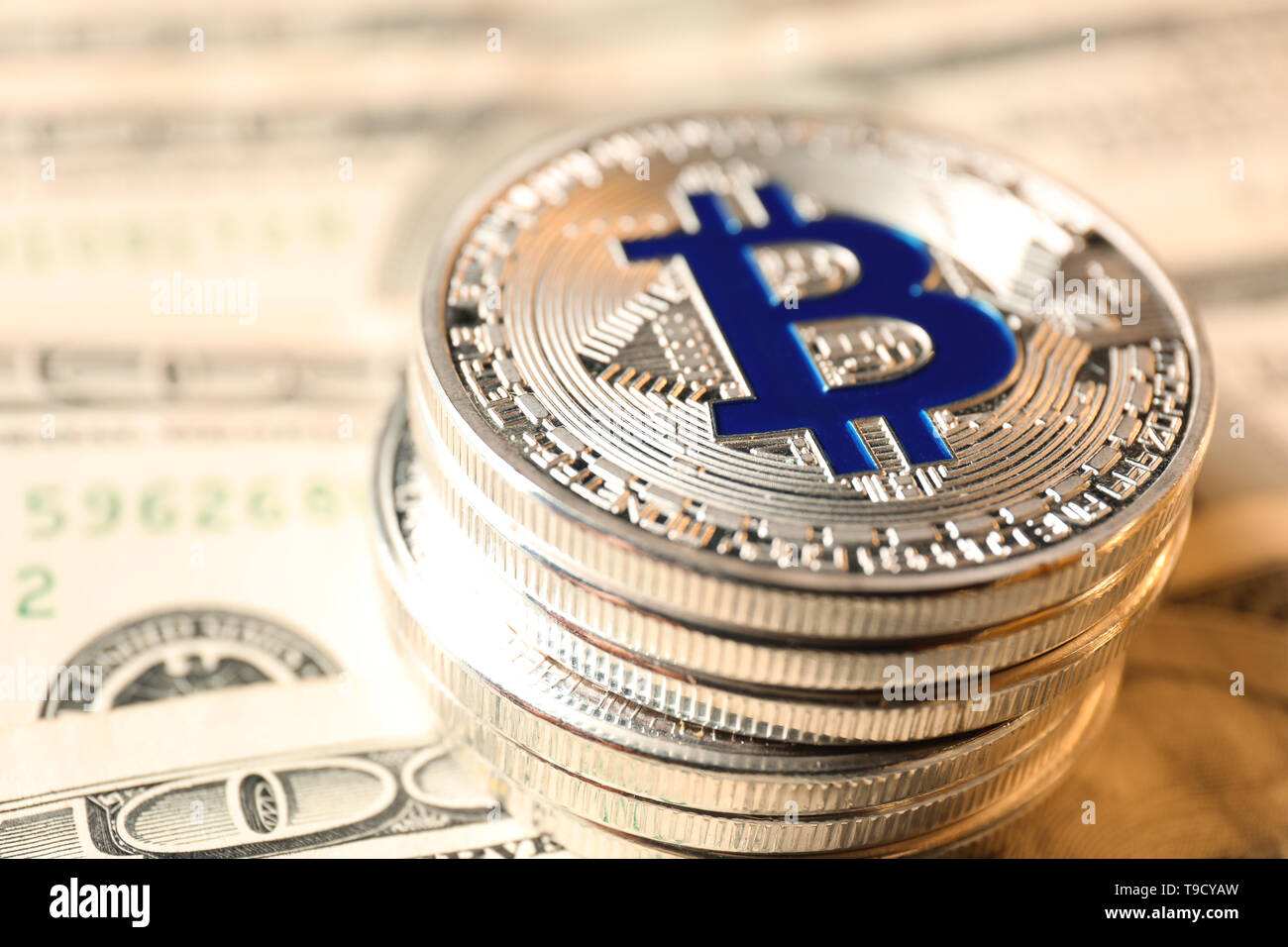 Bitcoins on dollar banknotes, closeup Stock Photo - Alamy