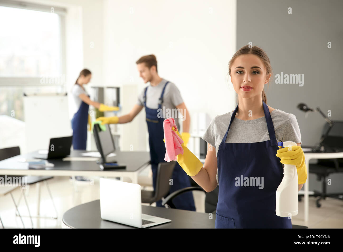 Female janitor with cleaning supplies in office Stock Photo - Alamy