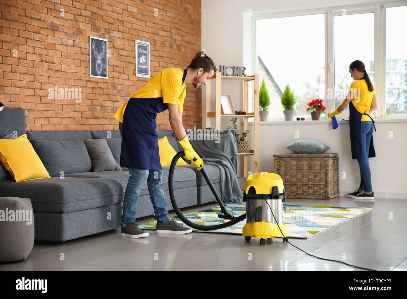 Team of janitors cleaning flat Stock Photo - Alamy