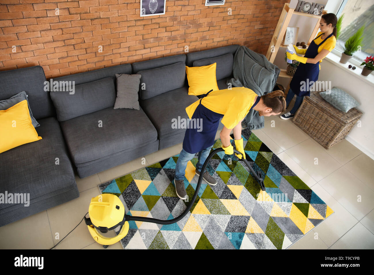 Team of janitors cleaning flat Stock Photo - Alamy