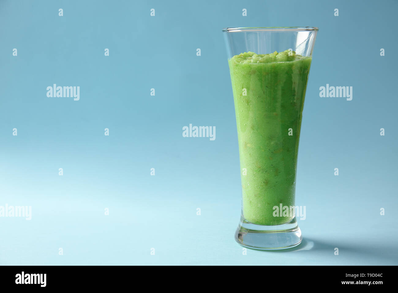 Glass of tasty green smoothie on color background Stock Photo - Alamy