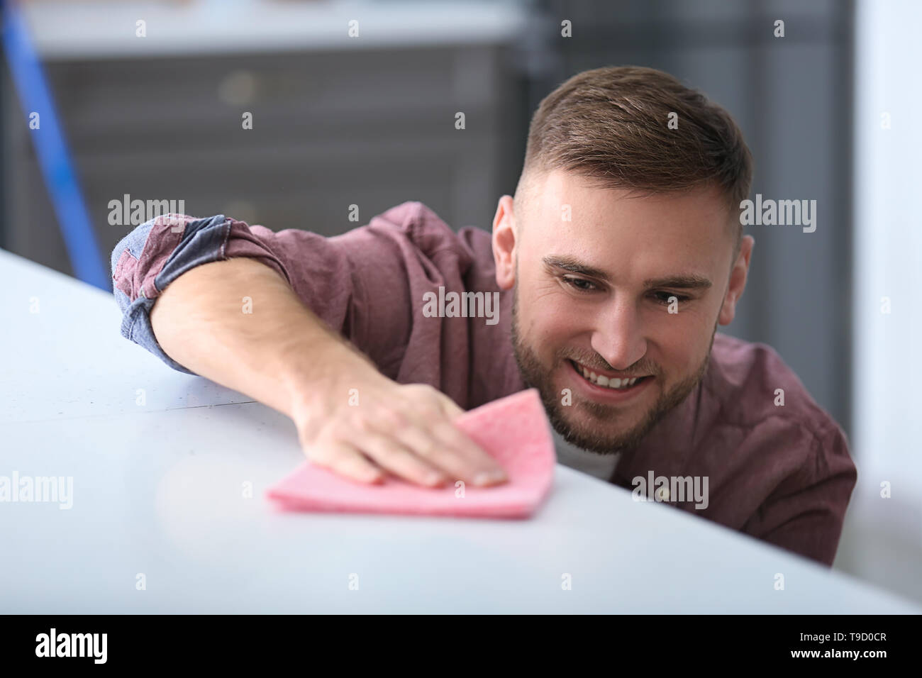 Young man cleaning his flat Stock Photo - Alamy