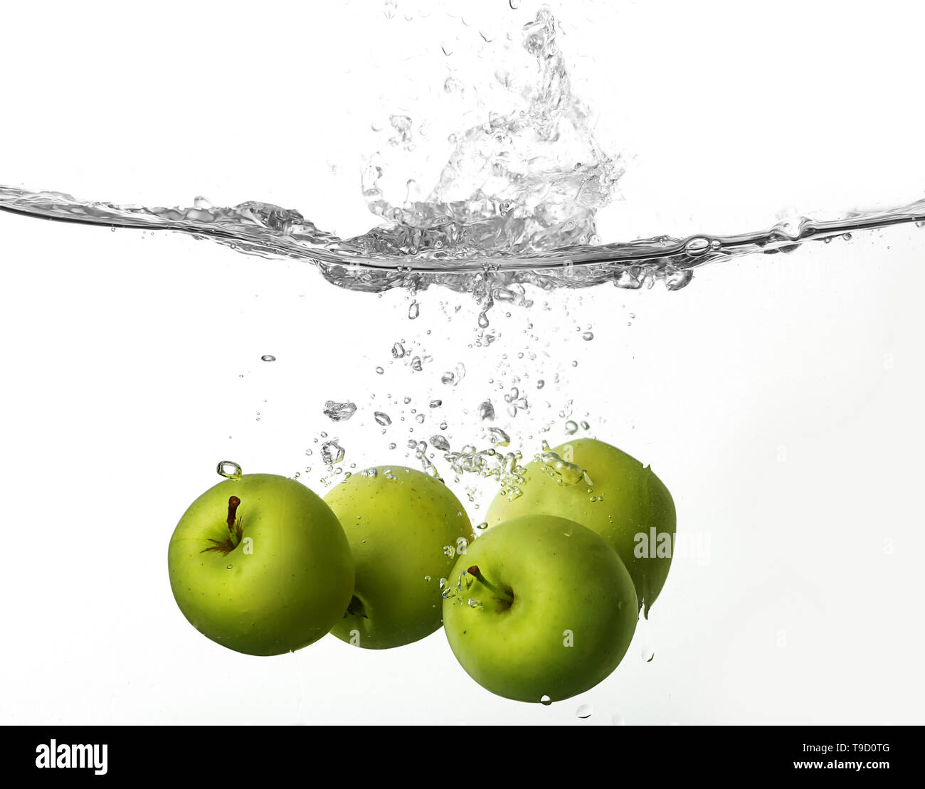 Falling of apples into water on white background Stock Photo - Alamy