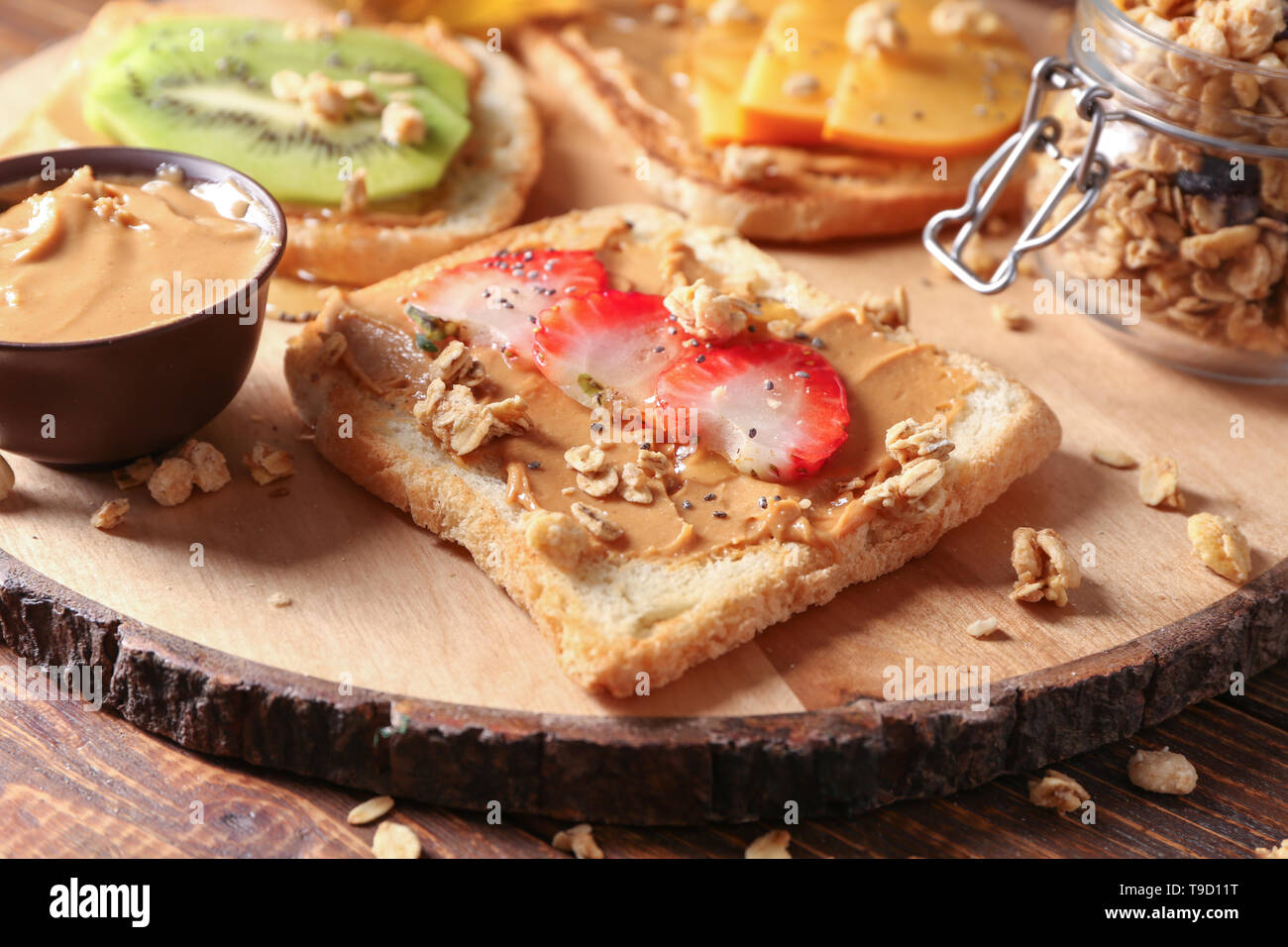 Board with different delicious toasts on table, closeup Stock Photo - Alamy