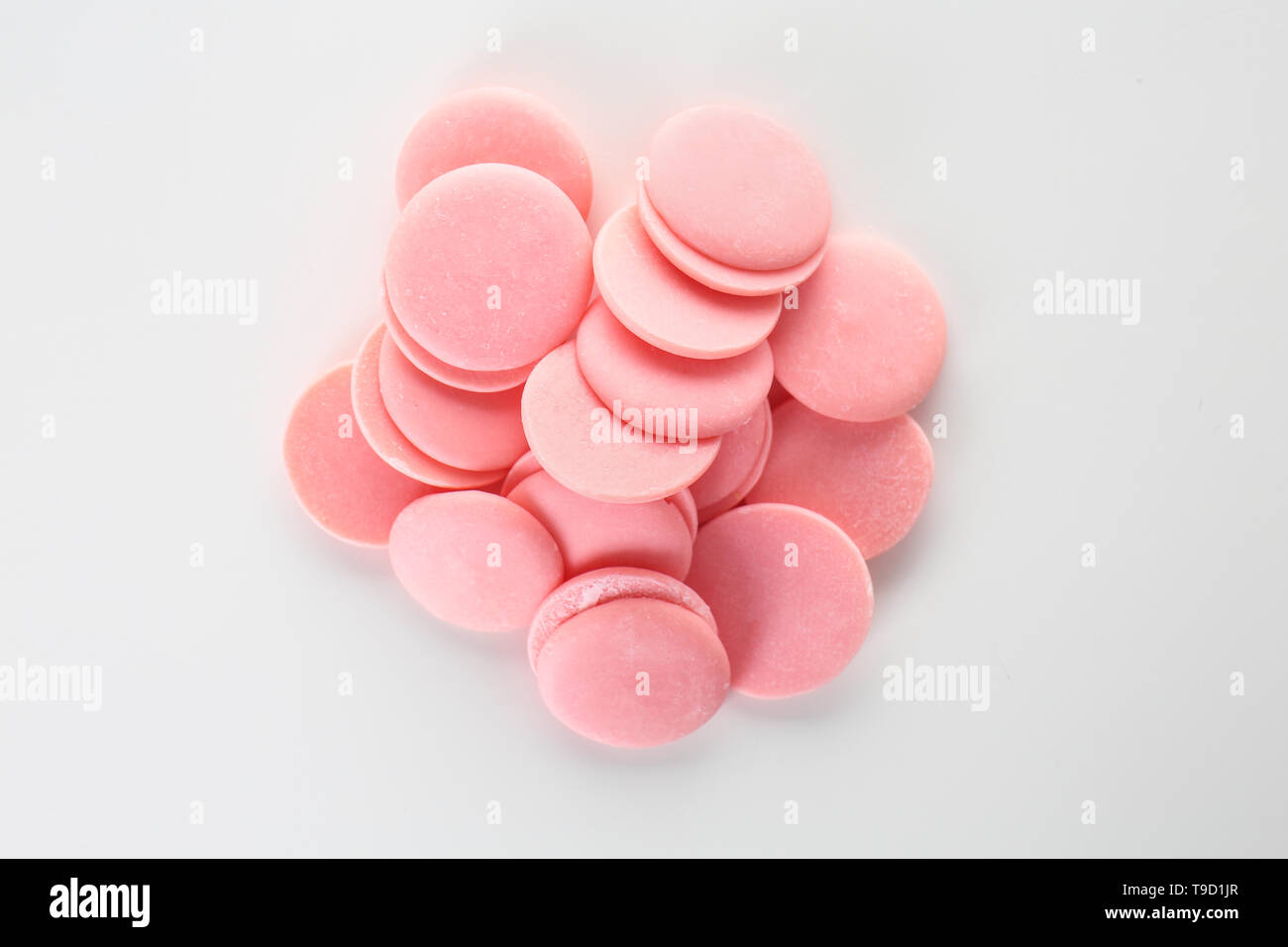 Delicious color chocolate chips on white background Stock Photo - Alamy