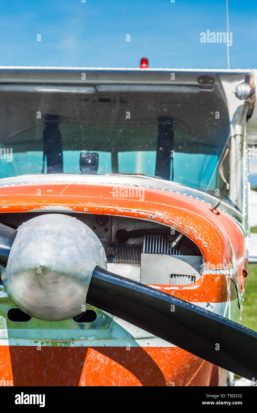 Small light utility aircraft, worn red and white paint, front view of ...