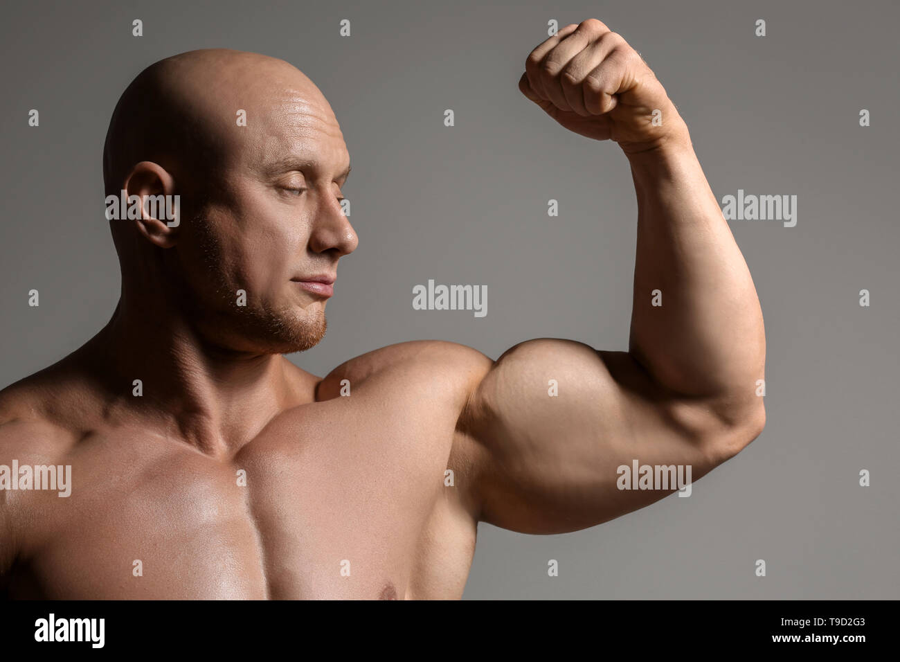 Muscular bodybuilder on grey background Stock Photo - Alamy