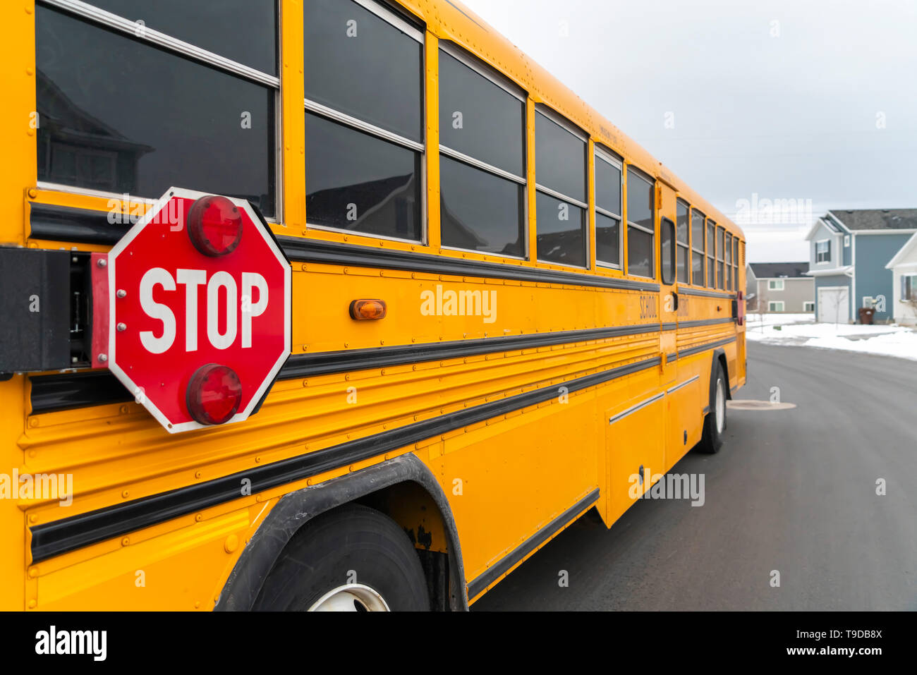 Exterior view of a yellow school bus with a red stop sign and signal ...