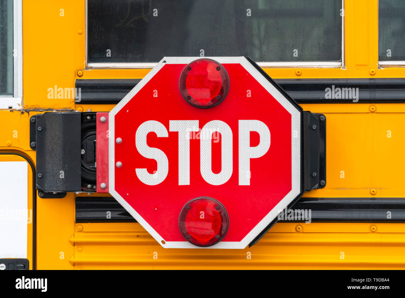 Close up of an octagon shaped red stop sign with signal lights on a ...