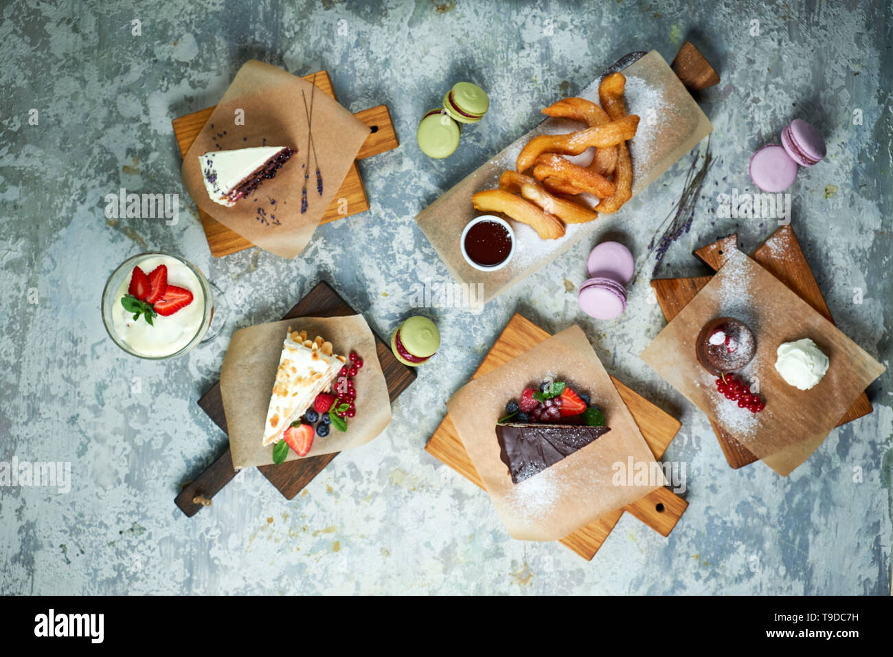 Assorted sweet desserts: cake, churos, meringue roll, ice cream ...