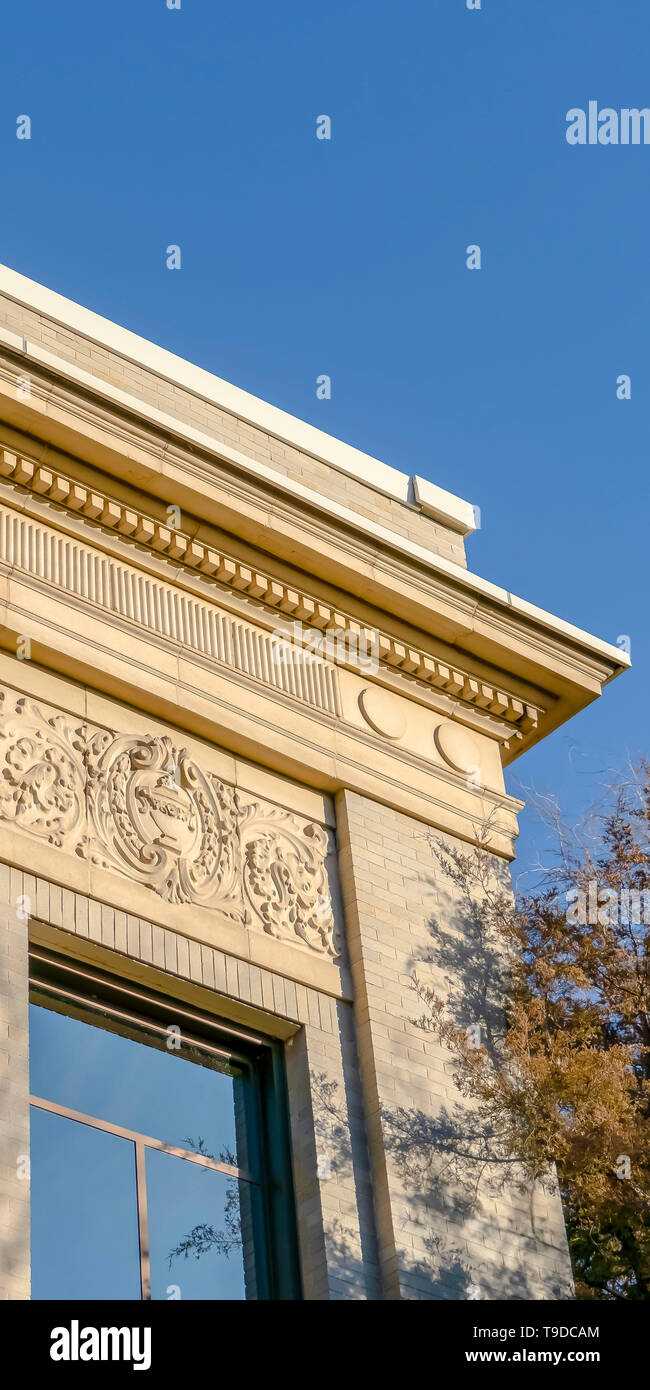 Vertical Building with glass windows reflecting the clear blue sky on a ...