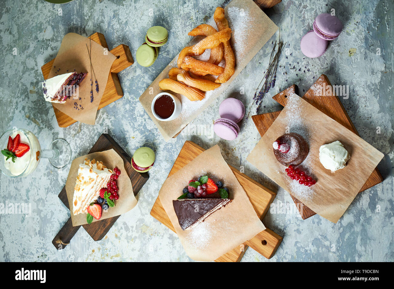 Assorted sweet desserts: cake, churos, meringue roll, ice cream ...