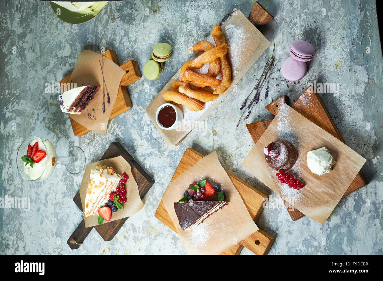 Assorted sweet desserts: cake, churos, meringue roll, ice cream ...