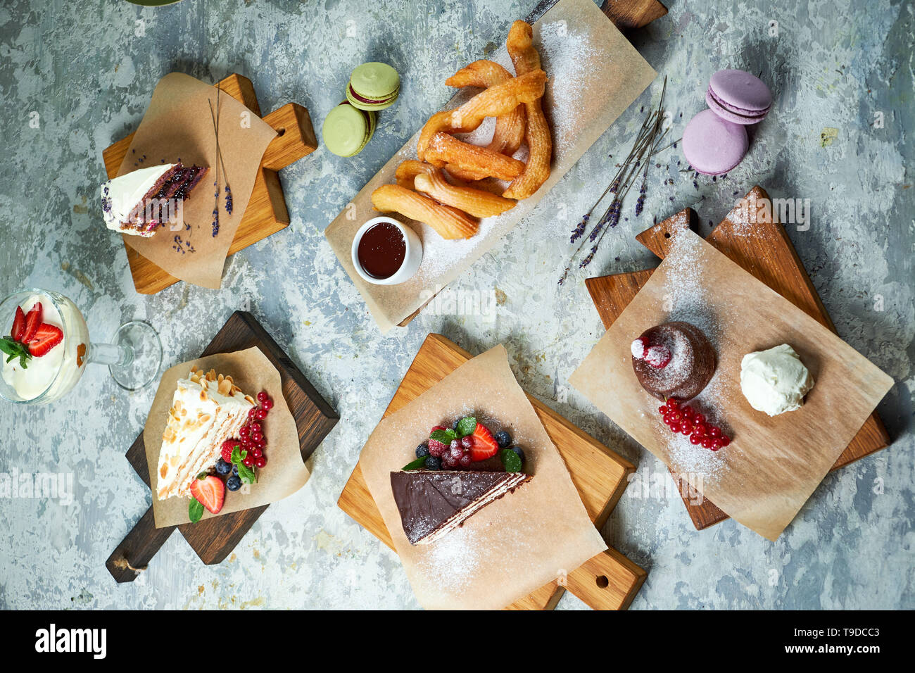 Assorted sweet desserts: cake, churos, meringue roll, ice cream ...