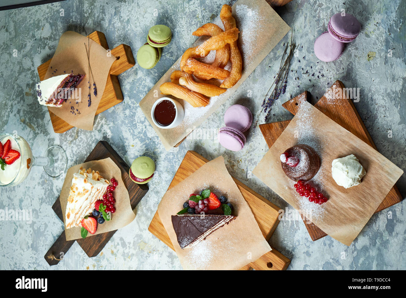 Assorted sweet desserts: cake, churos, meringue roll, ice cream ...