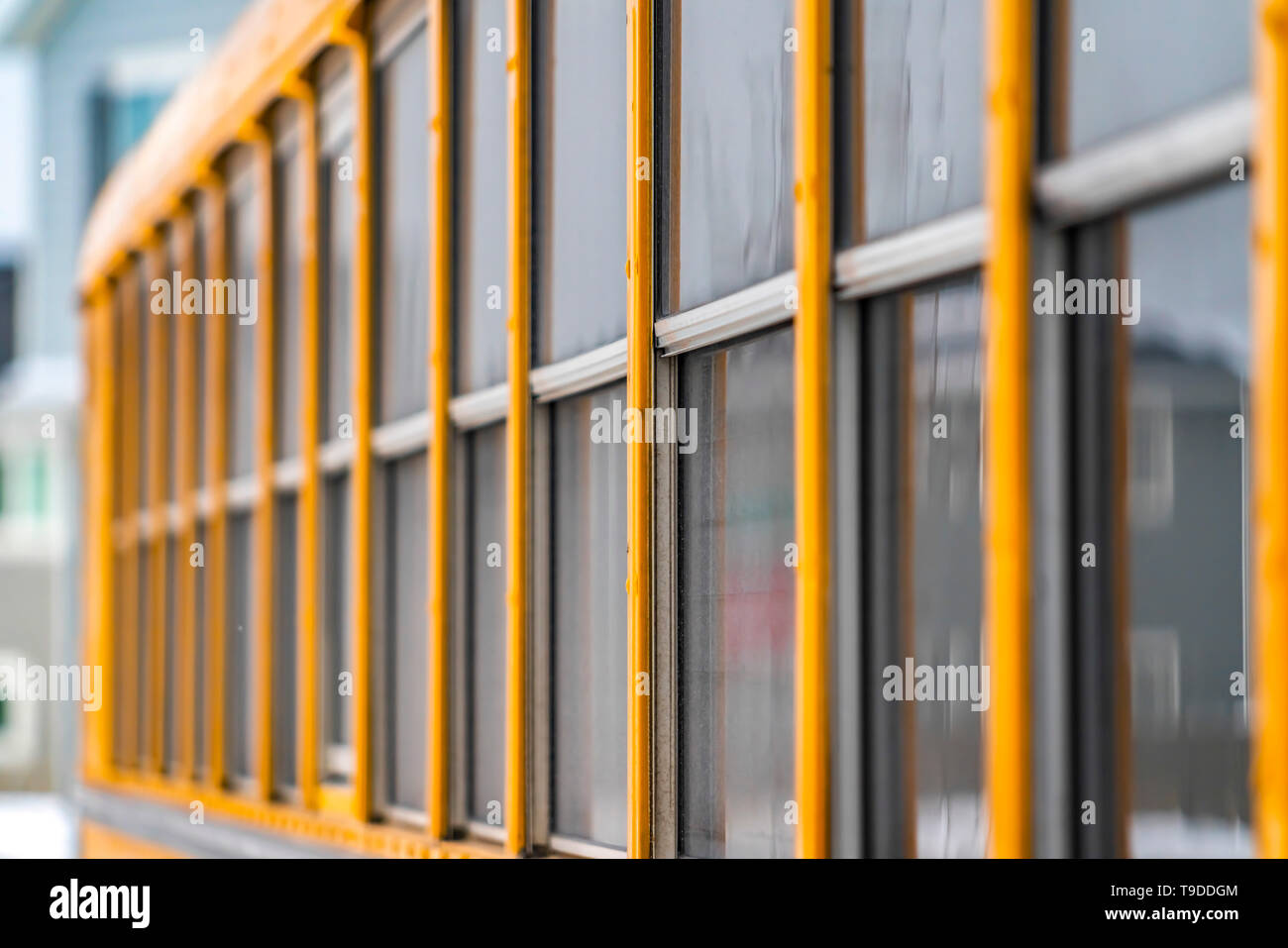Exterior view of a yellow school bus with a close up on the glass ...