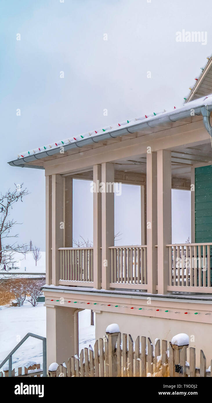 Vertical Home in Daybreak amid a snow covered landscape Stock Photo - Alamy