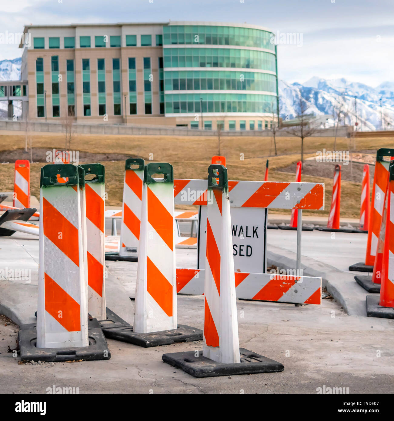 Clear Square Sidewalk Closed sign and road safety poles on a paved road ...